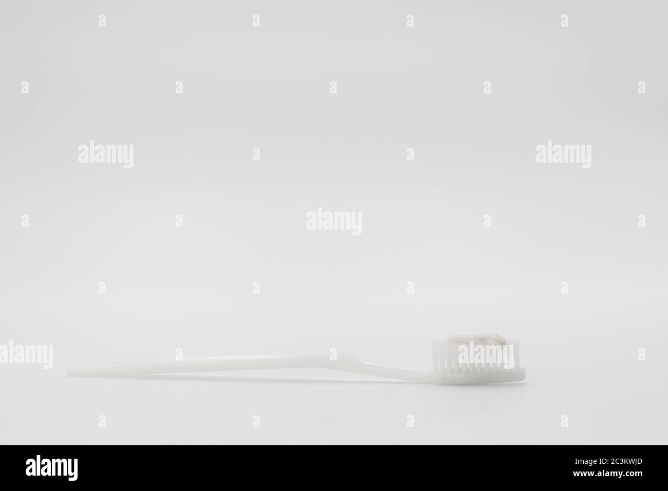 Isolated simple and normal white toothbrush with small toothpaste on ...