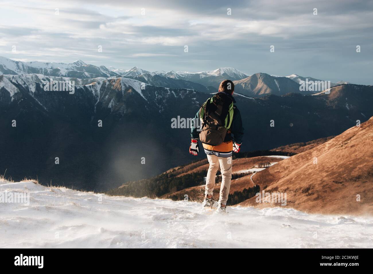 Man standing on the mountain covered with snow Stock Photo - Alamy