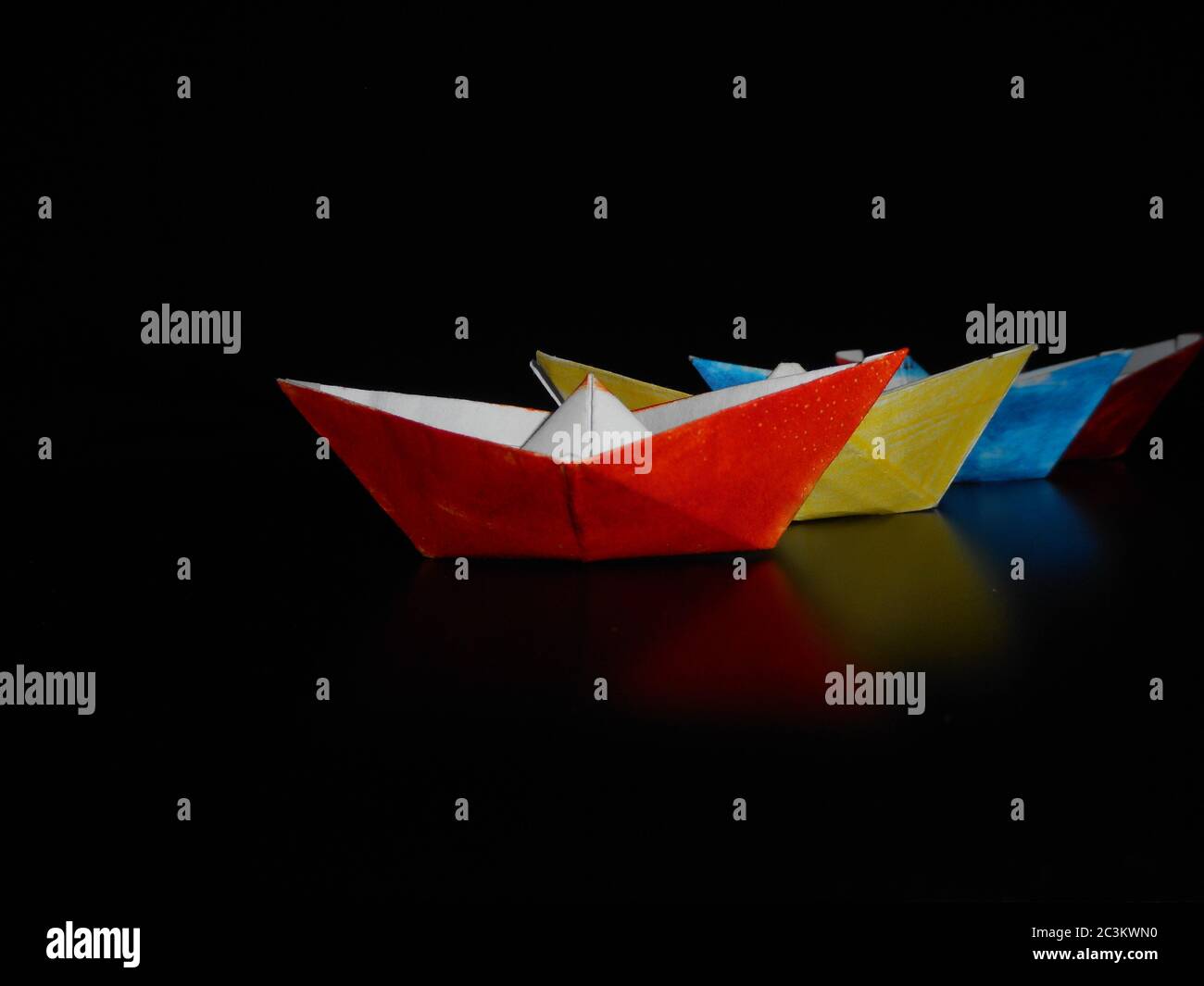 paper boats,over background as black Stock Photo - Alamy