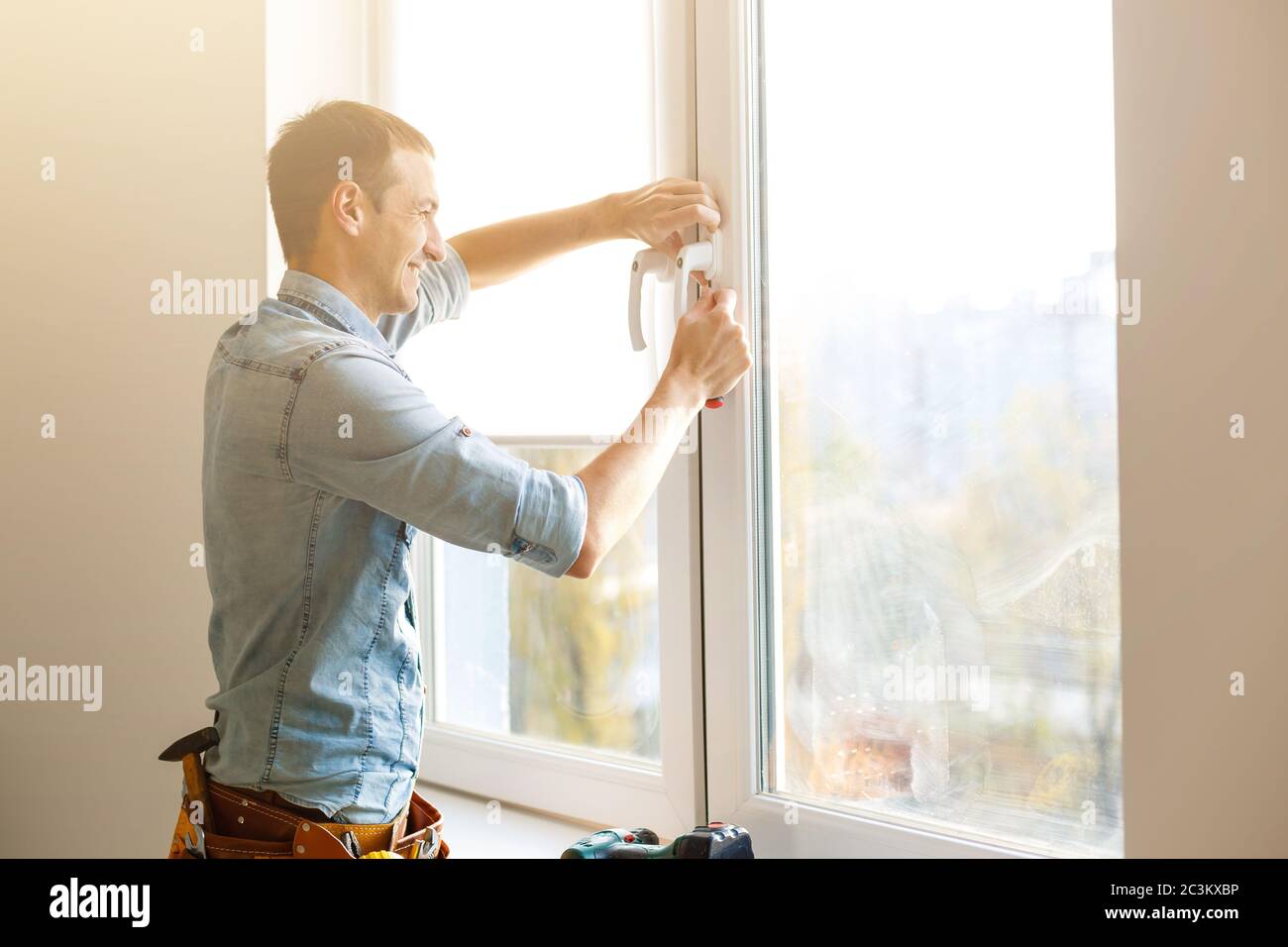 Close-up of a handyman fixing window frame Stock Photo - Alamy