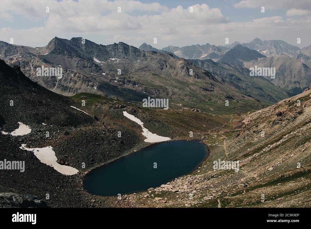 Lake surrounded by mountains during daytime Stock Photo - Alamy
