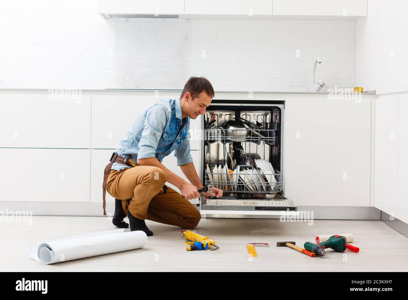 A young boy sitting on a counter Stock Photo - Alamy