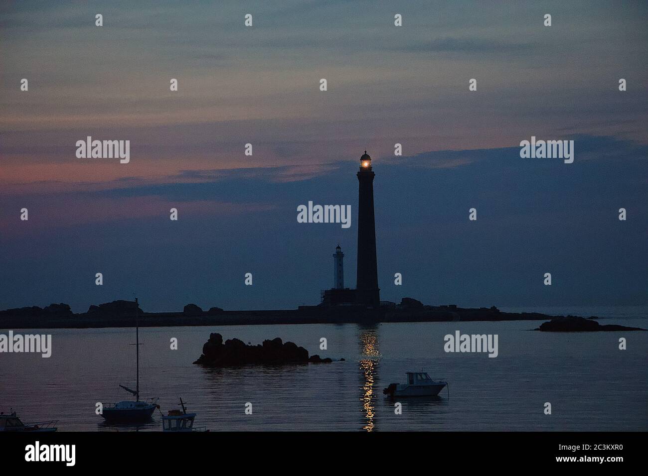 Beautiful view of the lighthouse in the sea with boats in the ...