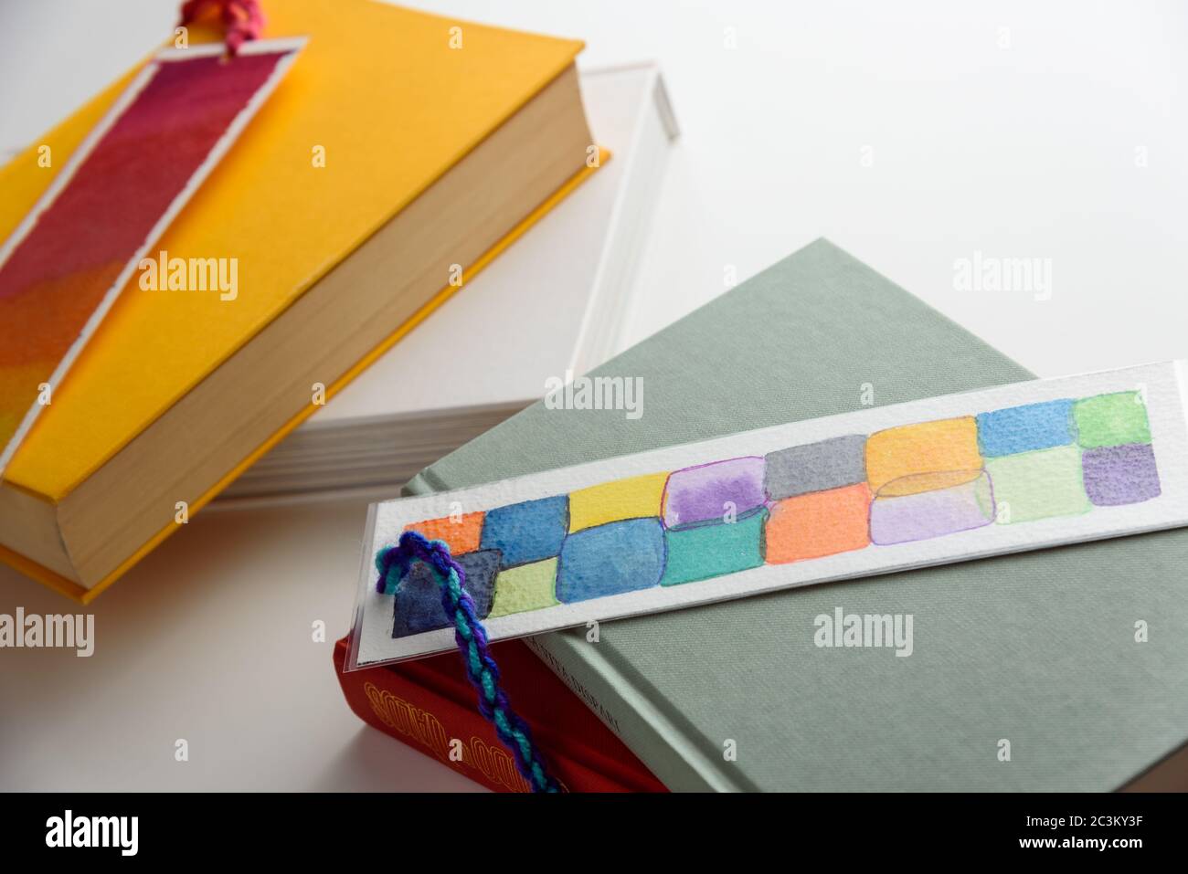 colorful bookmarks on a closed green and yellow books. education ...
