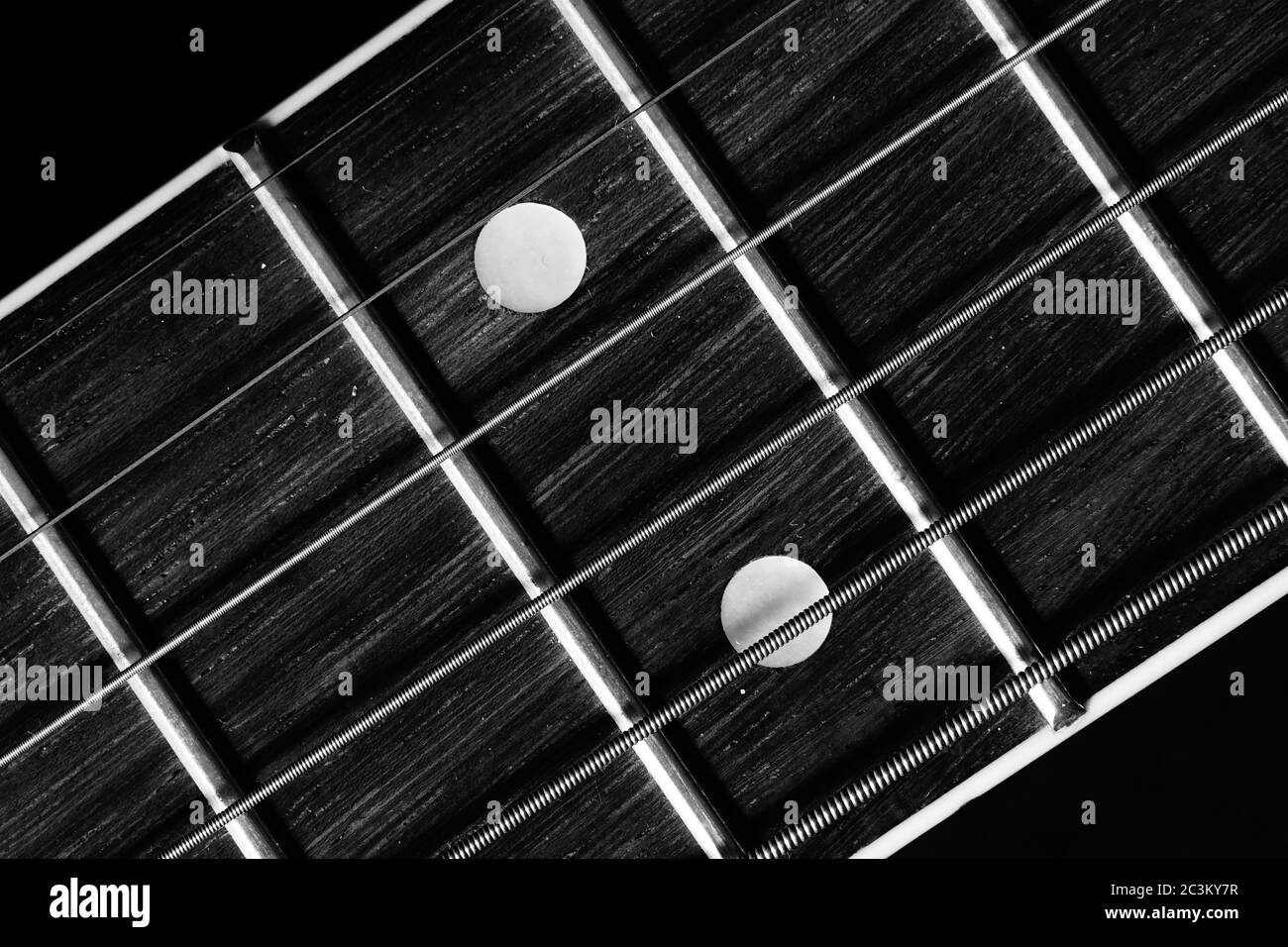 Closeup shot of fretboard of acoustic guitar isolated on black ...