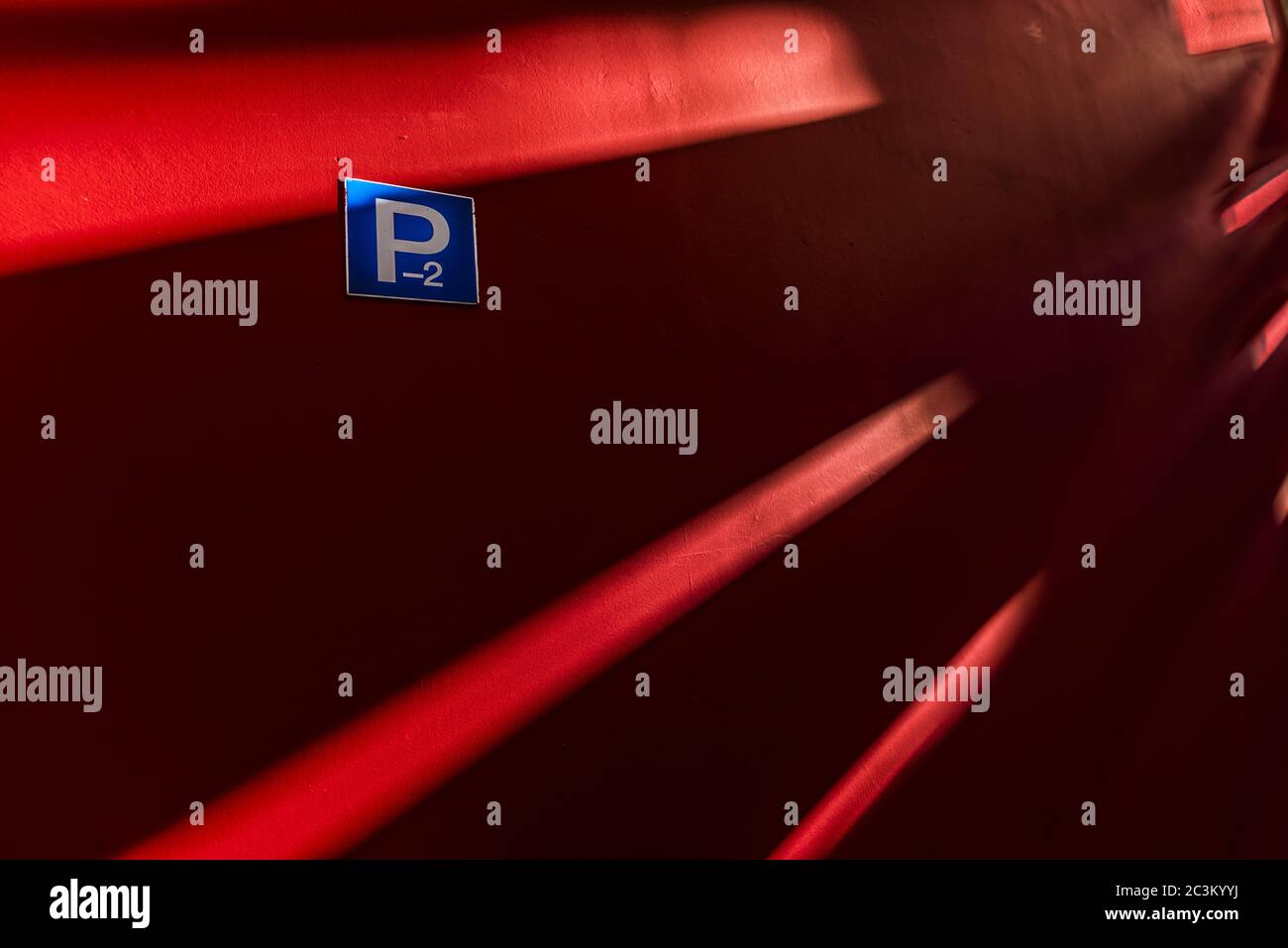 Low angle shot of a parking level sign on a red wall Stock Photo - Alamy
