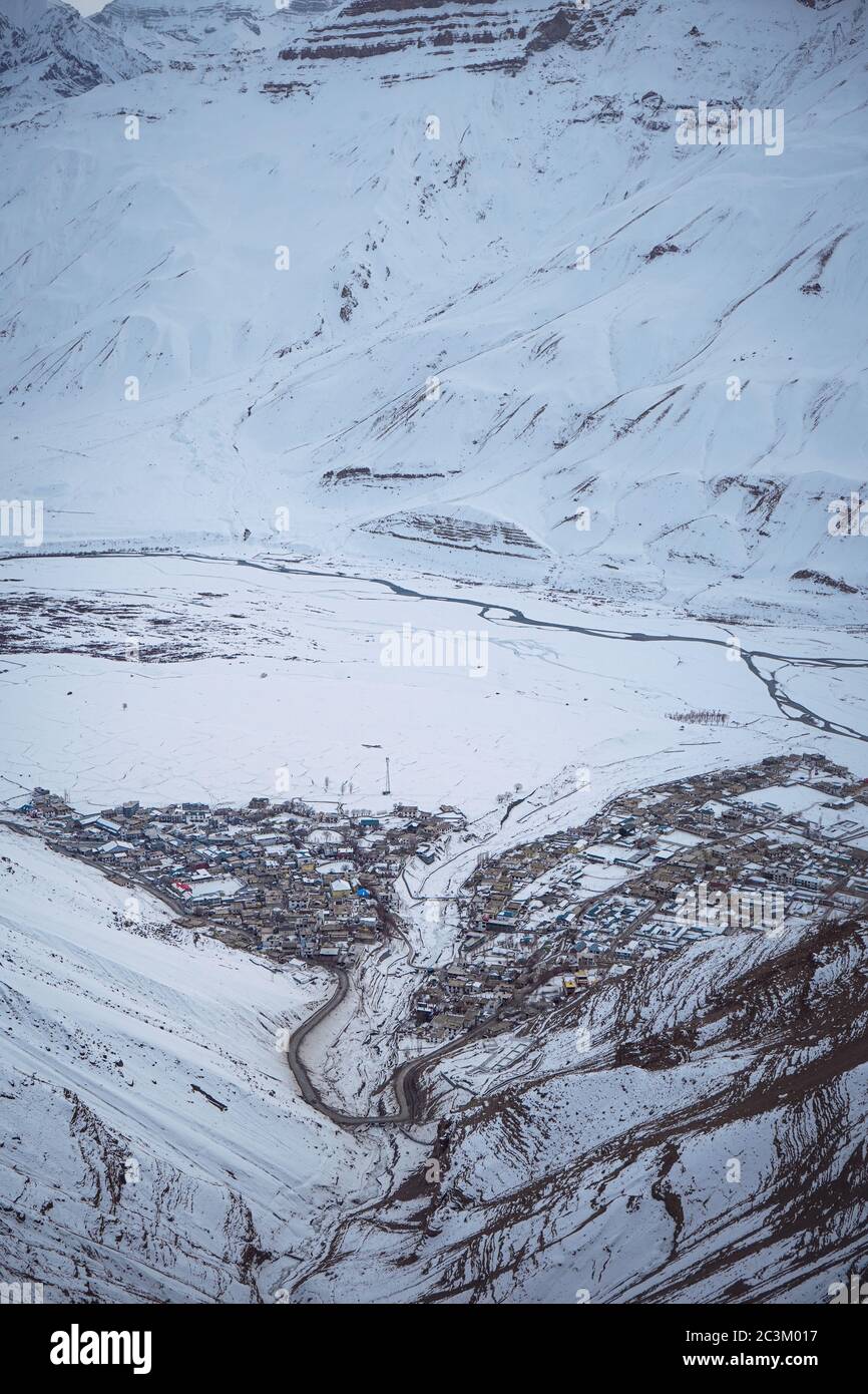 Aerial view of Kaza khaas with snow-covered mountains in the background ...
