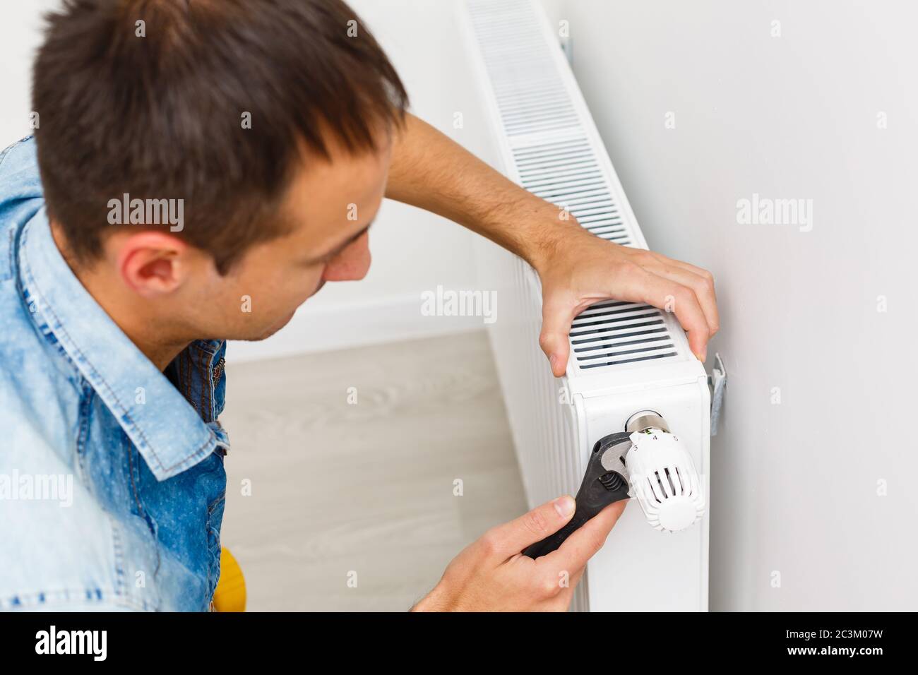 man fixing a heating radiator Stock Photo - Alamy