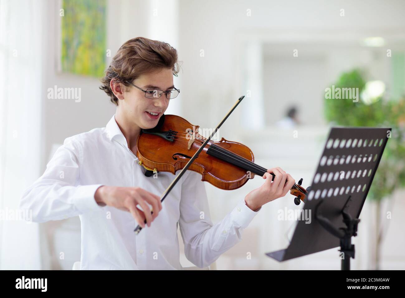 Man playing violin. Classical music instrument. Teenage boy practicing ...