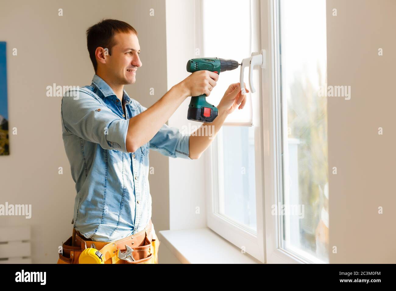Close-up of a handyman fixing window frame Stock Photo - Alamy