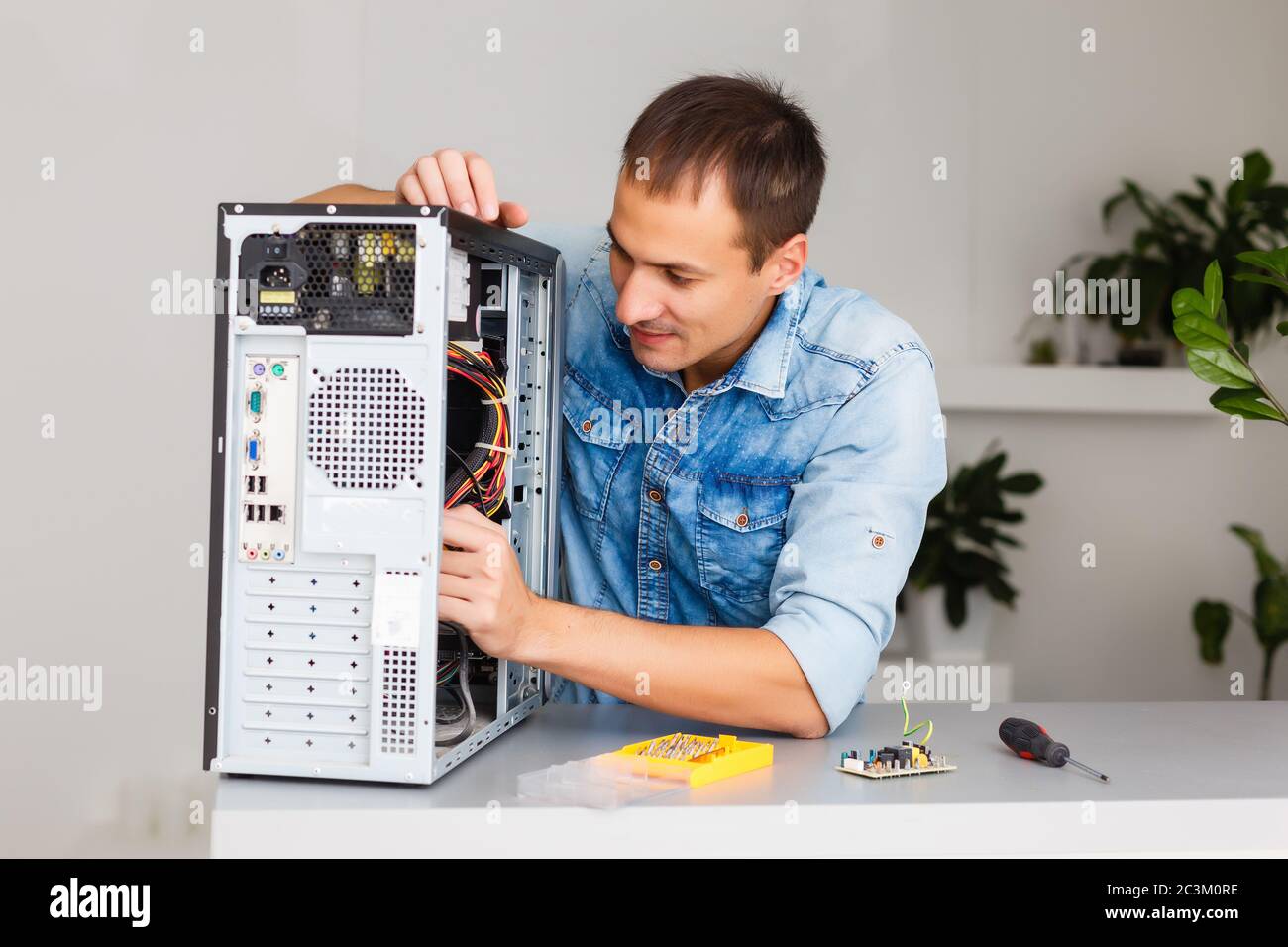 Computer engineer working on broken console in his office Stock Photo ...