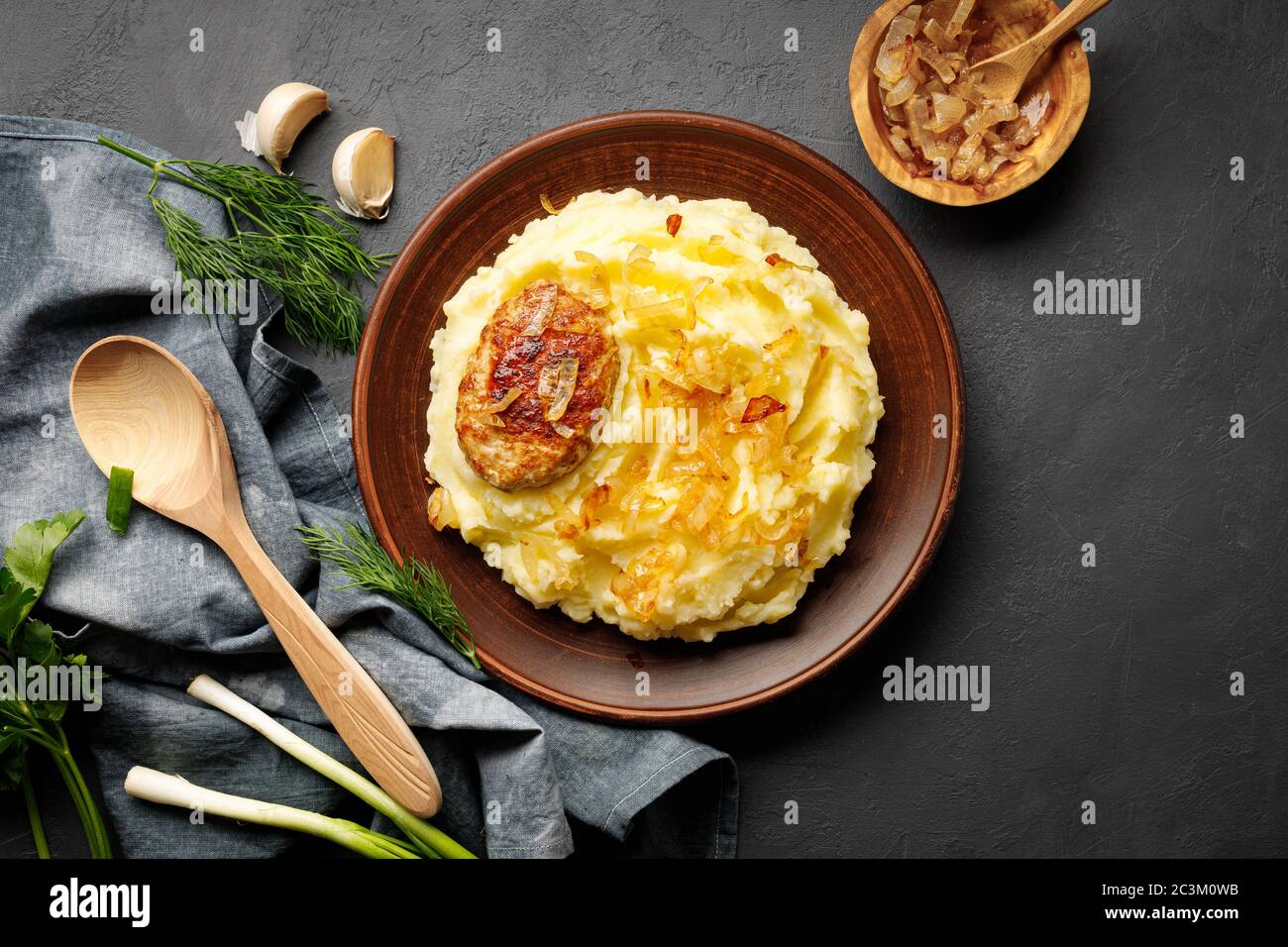 Mashed potatoes, boiled puree with fried onions and cutlet in a brown ...