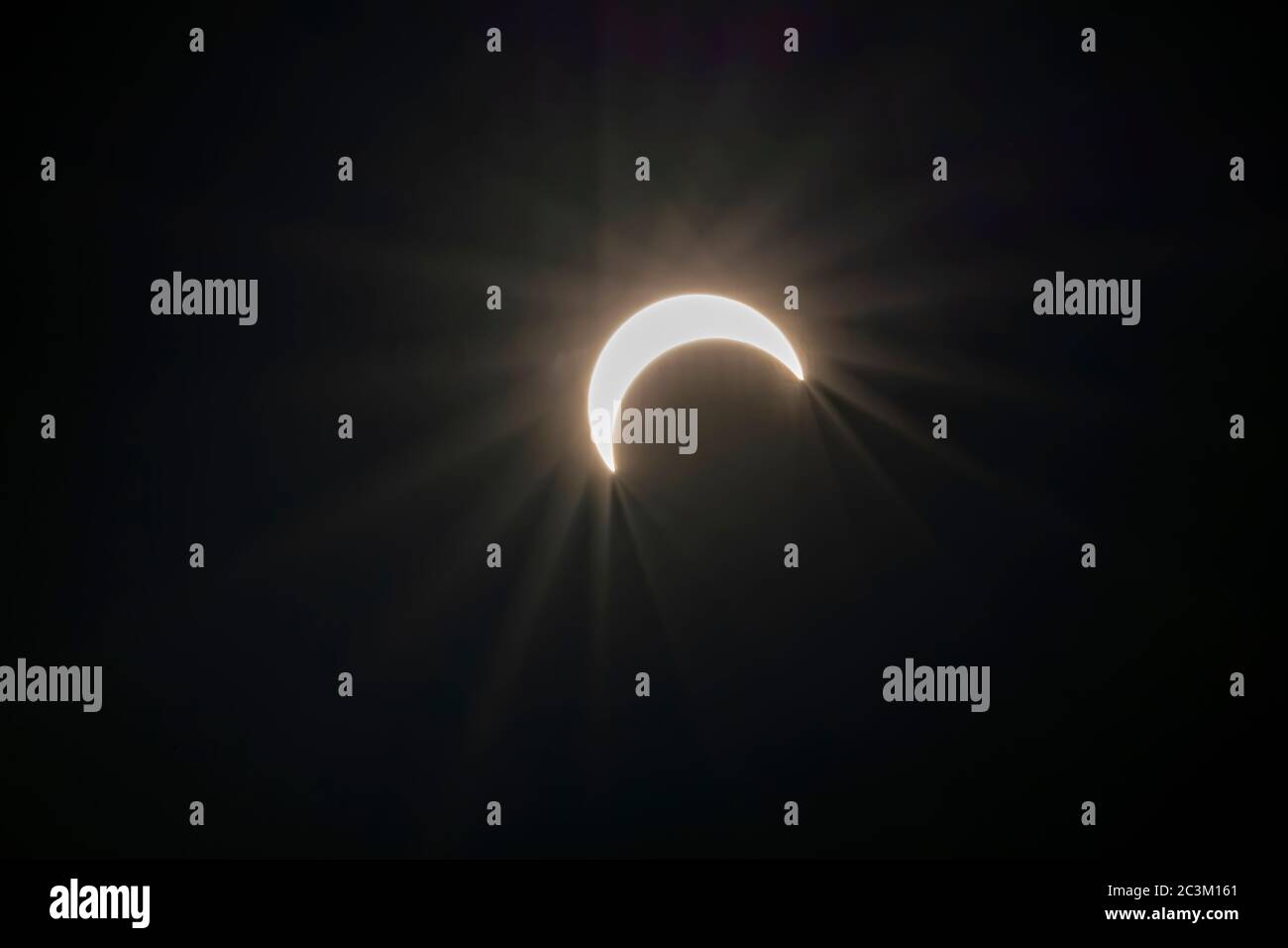 Partial solar eclipse as seen from Doha, Qatar Stock Photo - Alamy