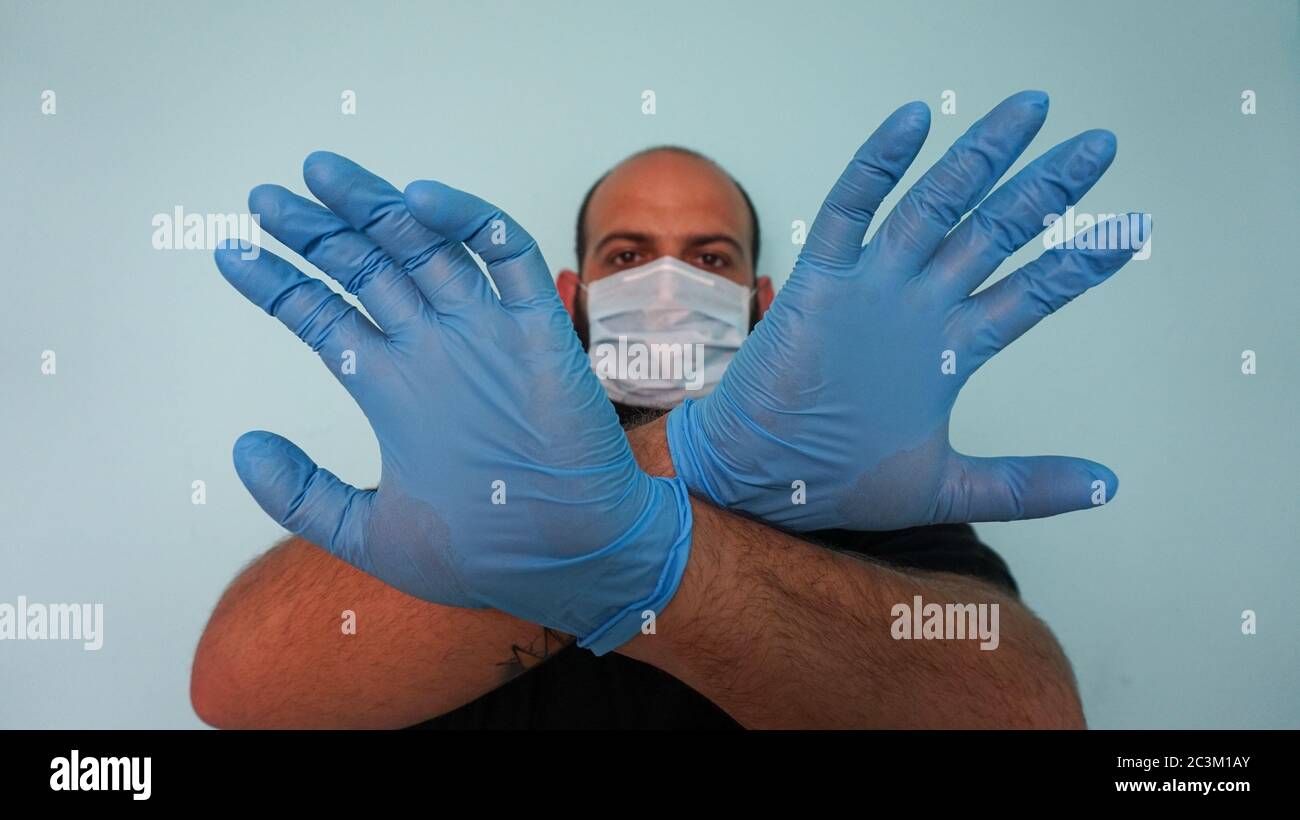Bearded male wearing a facemask and gloves with arms crossed Stock ...