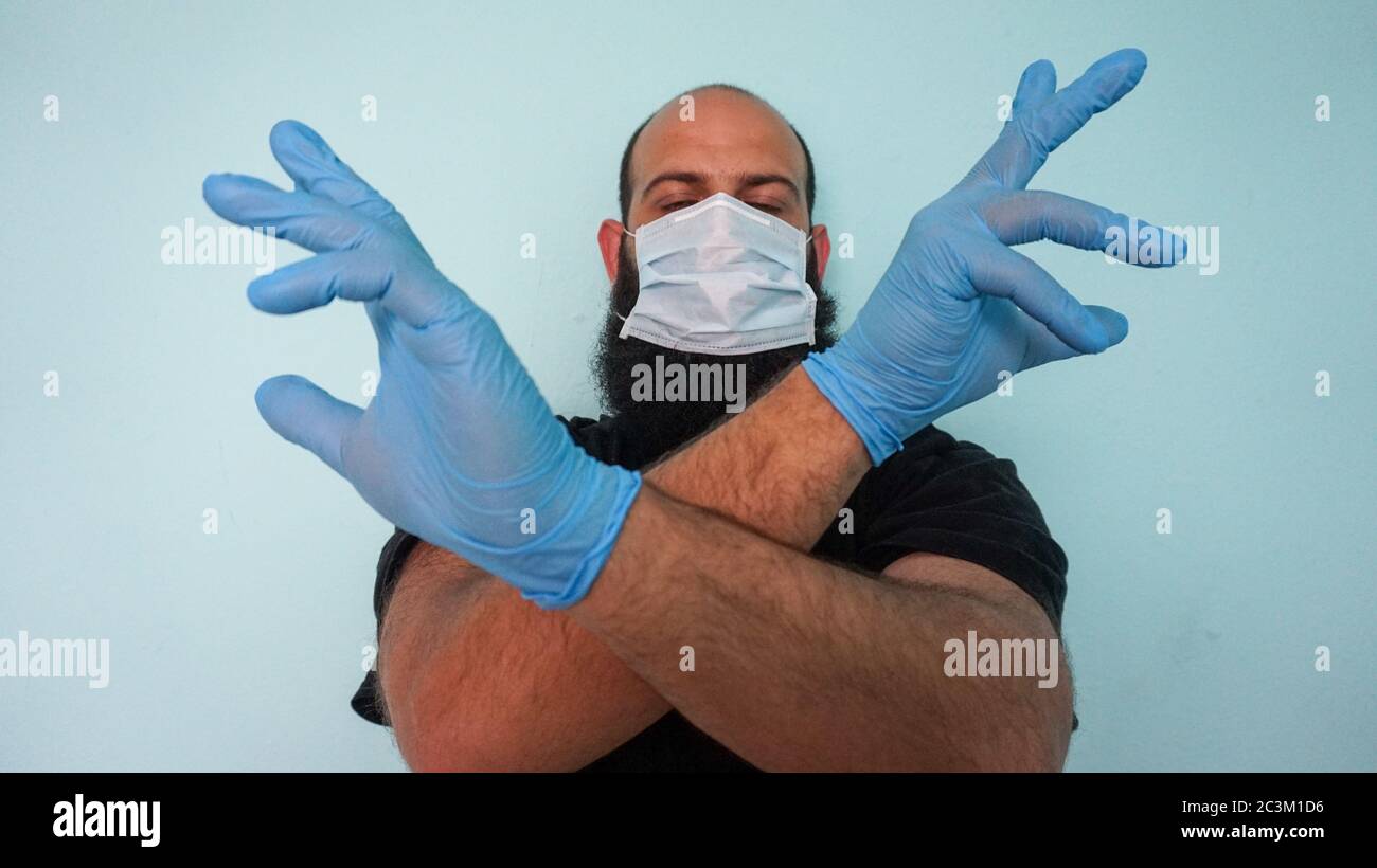 Bearded male wearing a facemask and gloves with arms crossed Stock ...