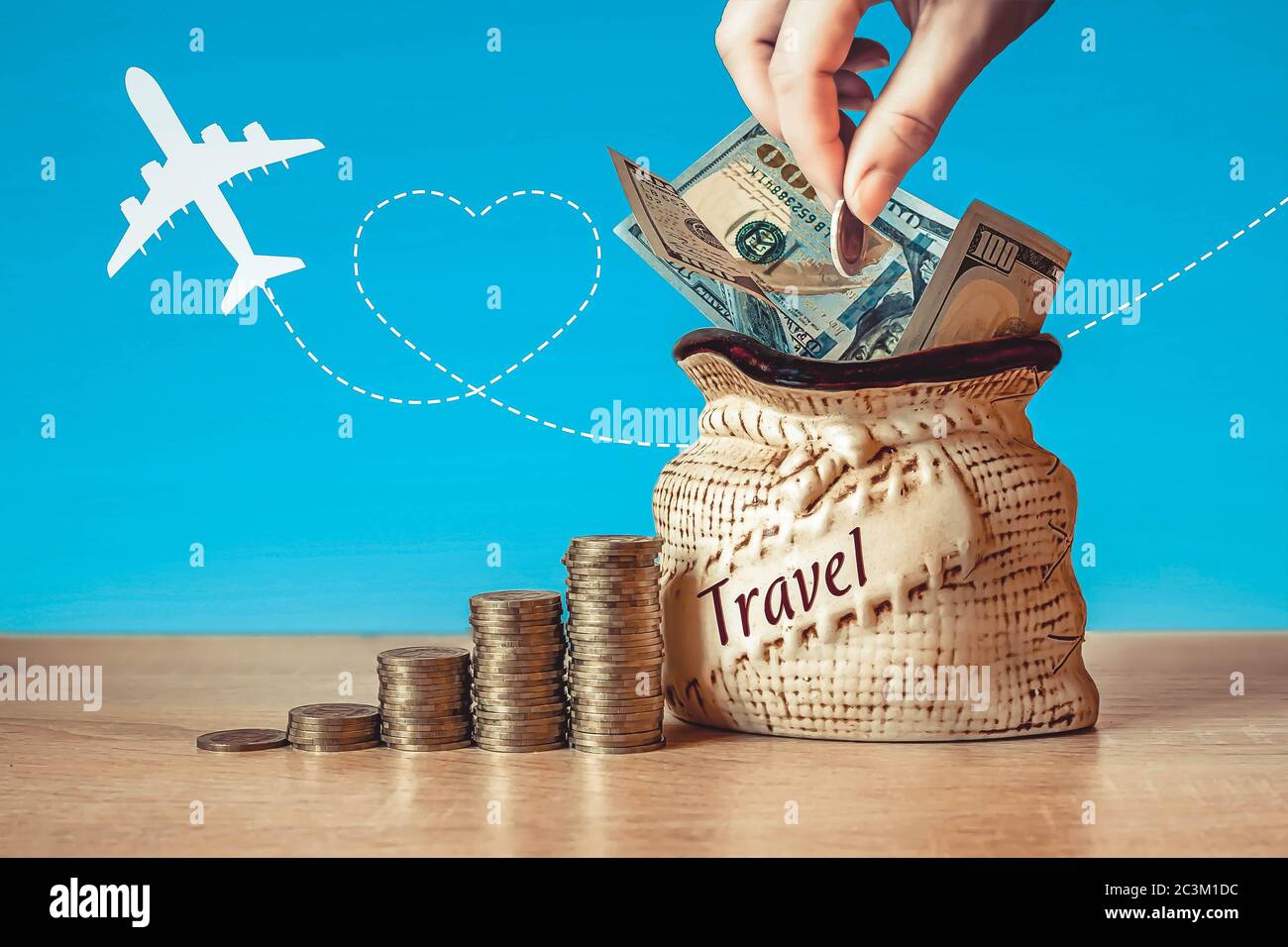 US dollar bills in Bag with coins Stack on table, blue background with ...