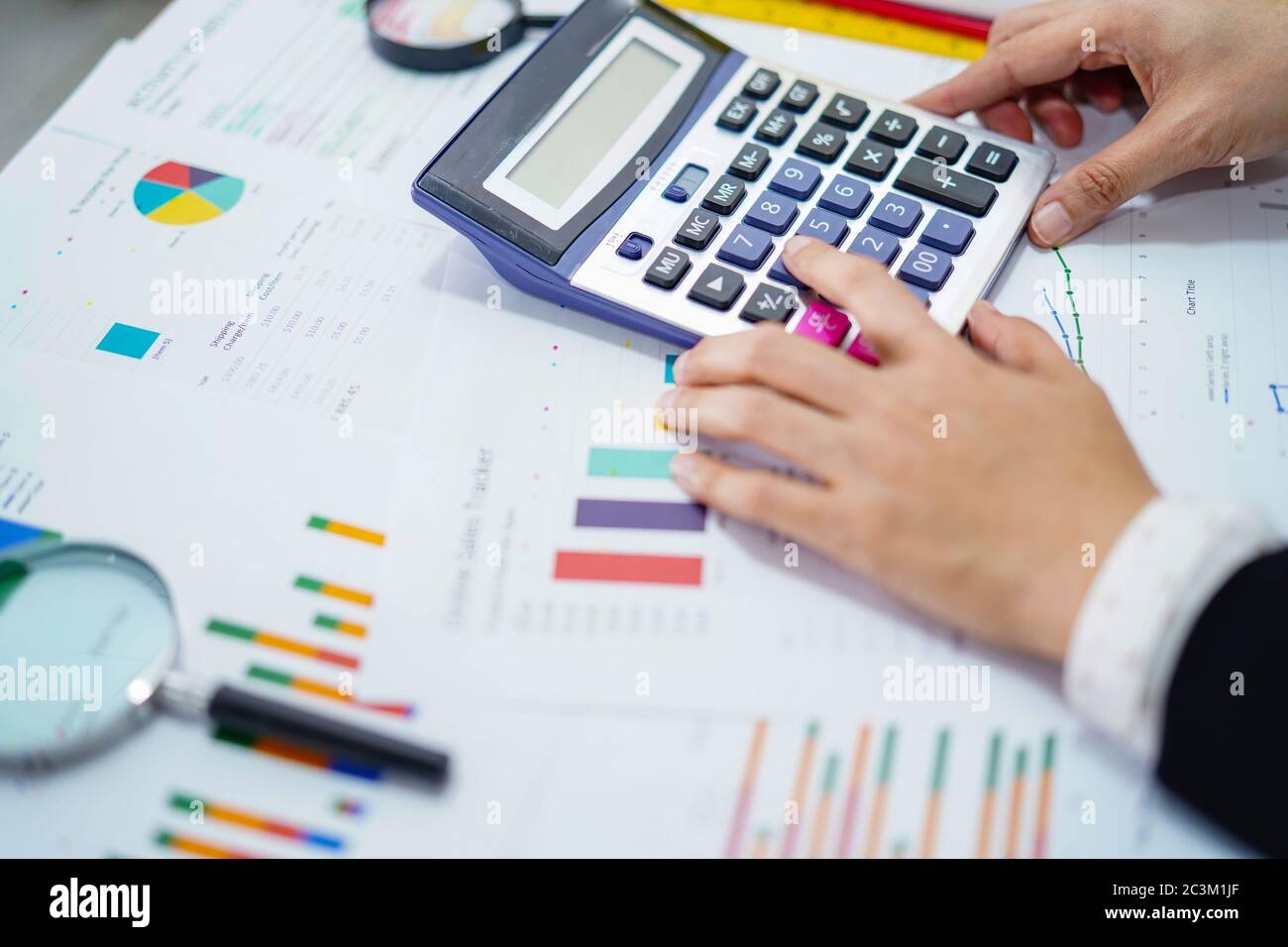 Accountant press calculator and working project accounting with graph ...