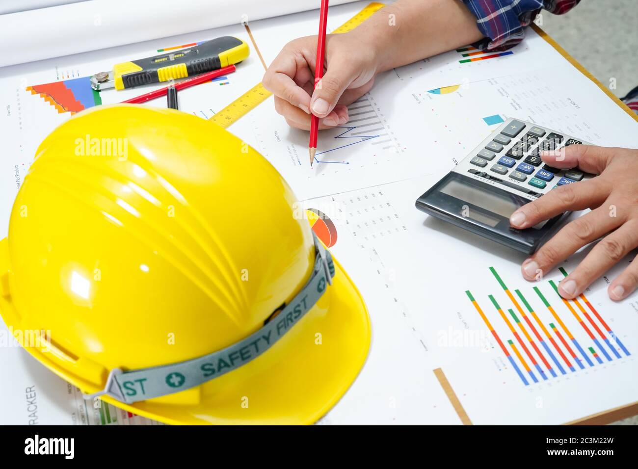 Architect or engineer working project accounting with graph with tools ...