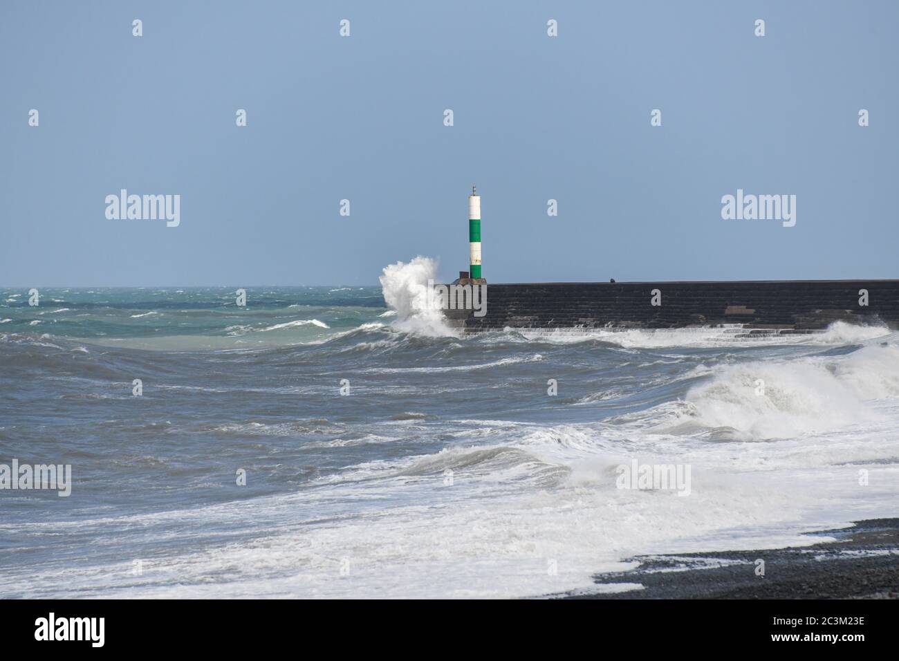 Harbour light at the end of the stone jetty at Aberystwyth Cardigan Bay ...