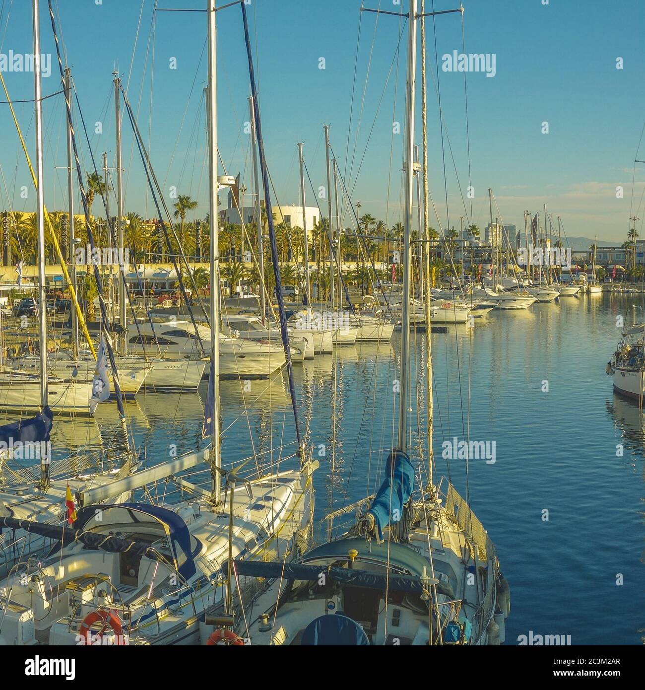 High angle shot of the sailing boats by the port on the calm and ...