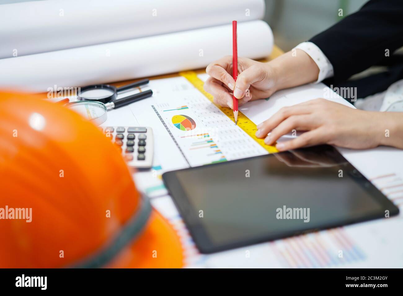 Architect or engineer working project accounting with graph with tools ...