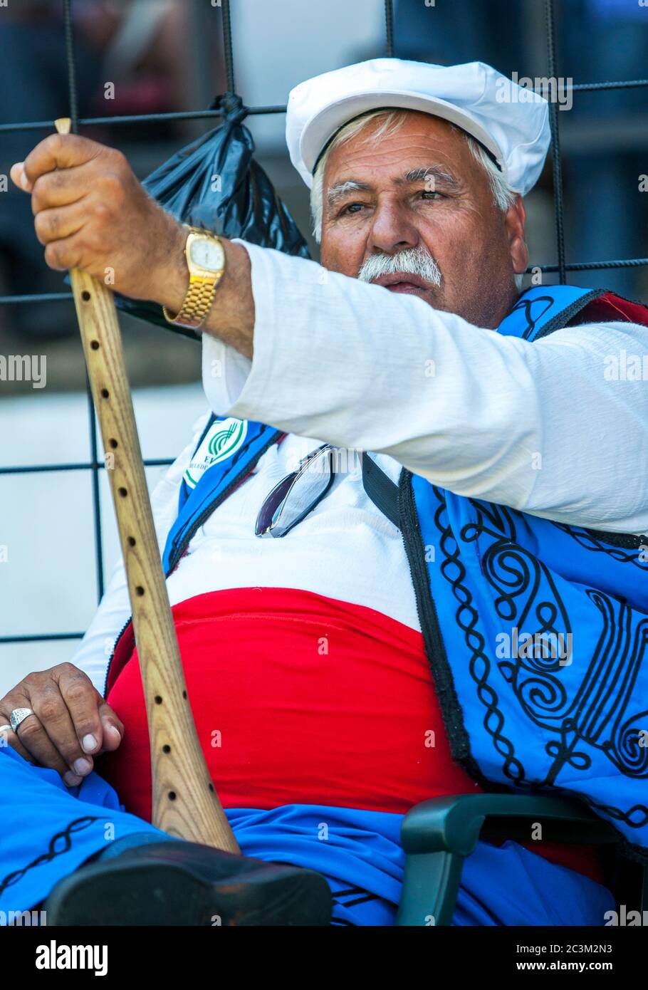 A gypsy musician holding his zurna relaxes between performances at the ...