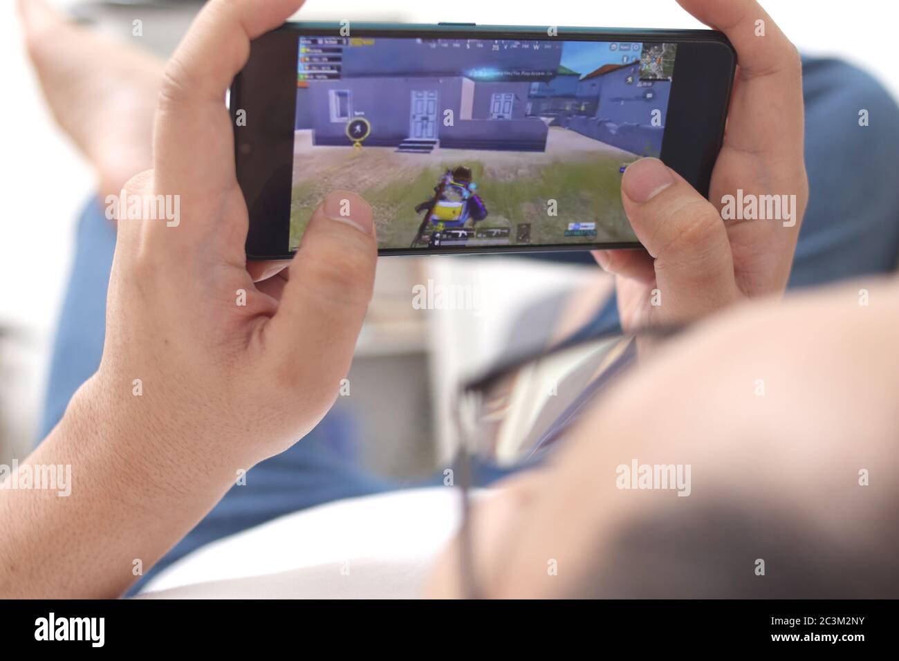 Male man gamer relaxing and playing video game on the smartphone ...