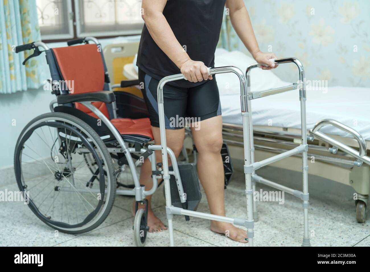 Asian middle-aged lady woman patient walk with walker at nursing ...