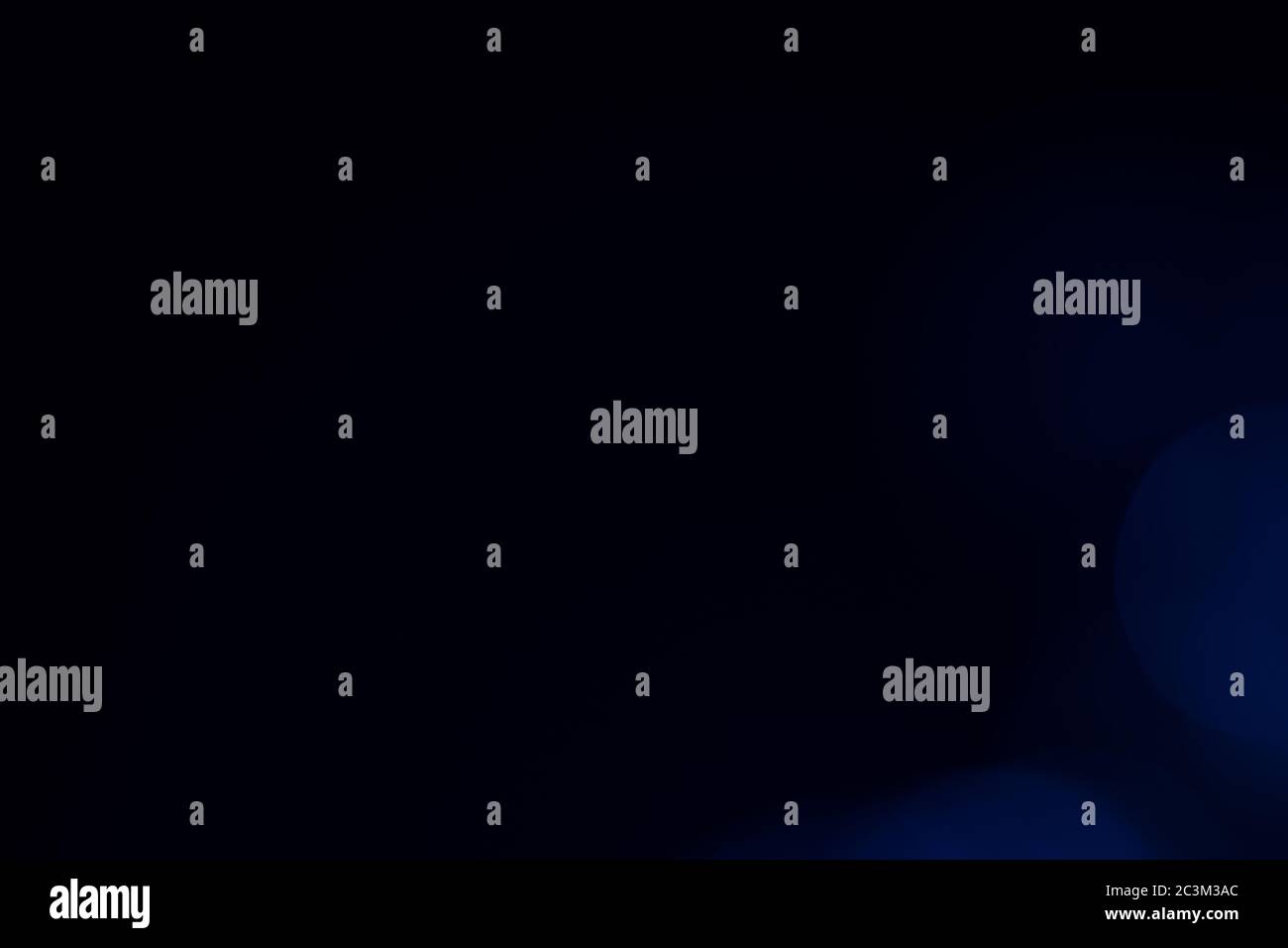 Dark background with faint blue bokeh lights for light leaks and ...