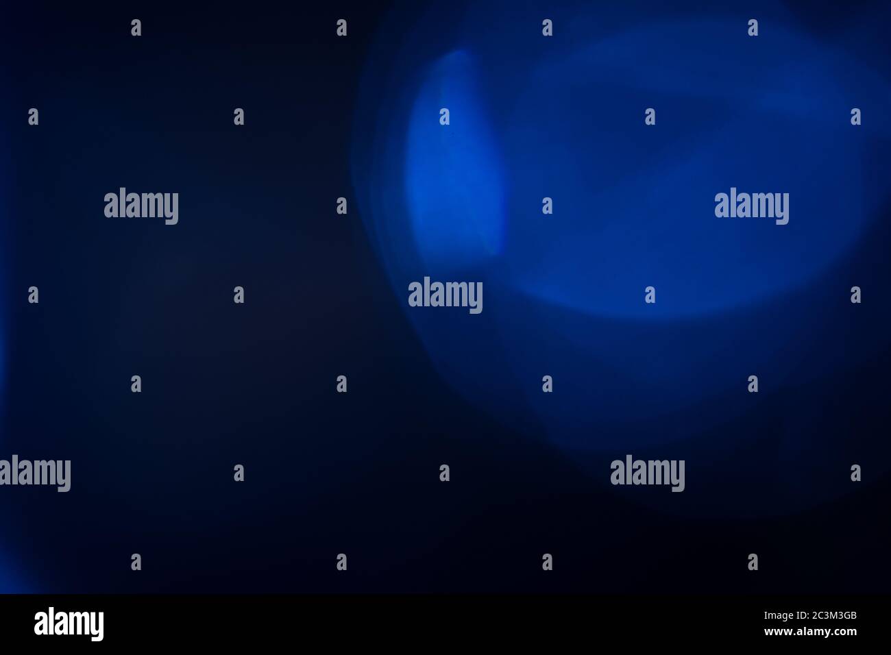 Dark background with faint blue bokeh lights for light leaks and ...