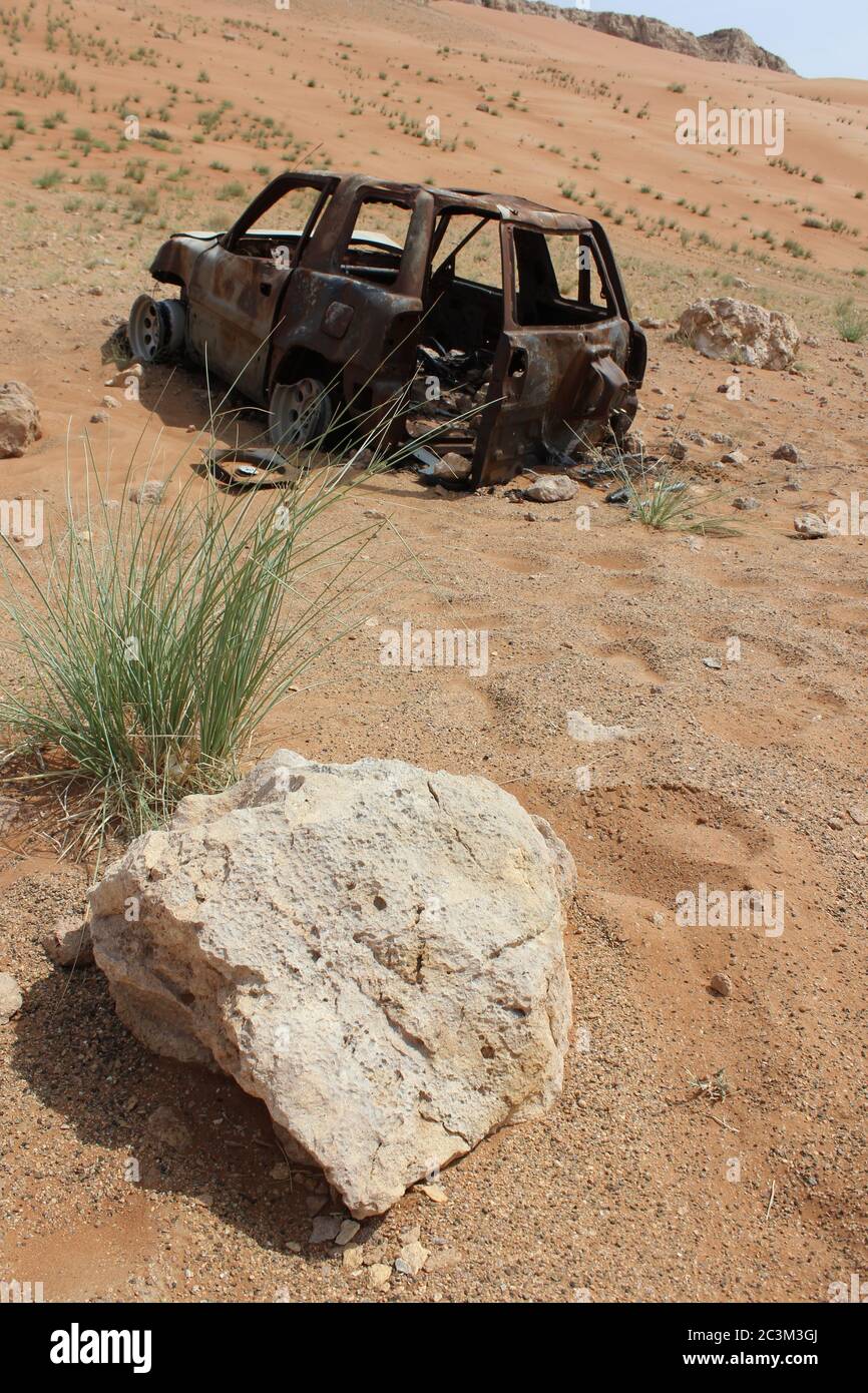 Burned out and rusty 4WD (four wheel drive) vehicle wreckage partially ...