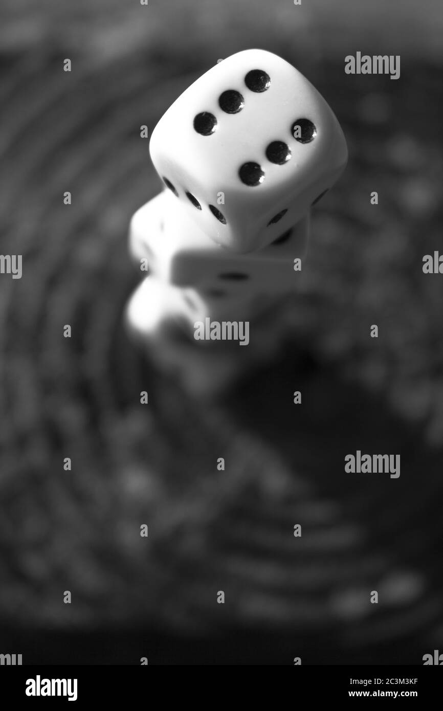 Vertical high angle closeup shot of the number six on a white dice ...