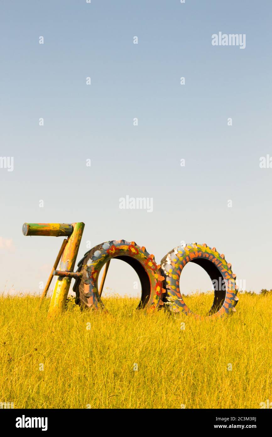 Number 700 made of painted wheels and woods in the field Stock Photo ...