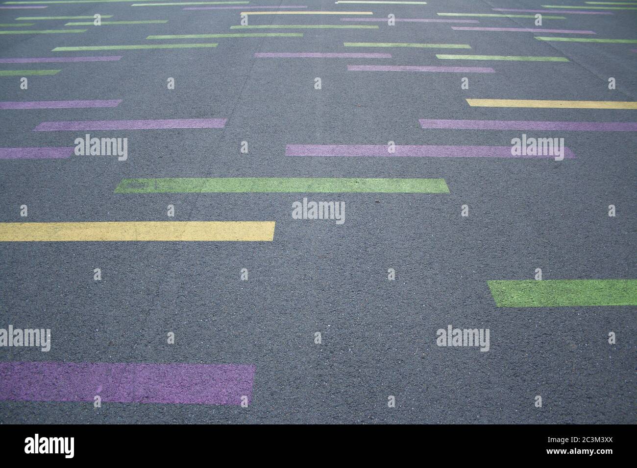Yellow, green and purple lines painted on the asphalt ground Stock ...