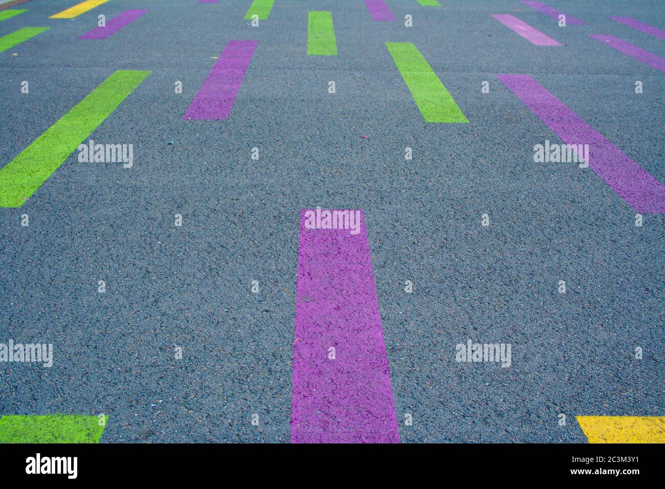 Green and purple lines painted on the asphalt ground Stock Photo - Alamy