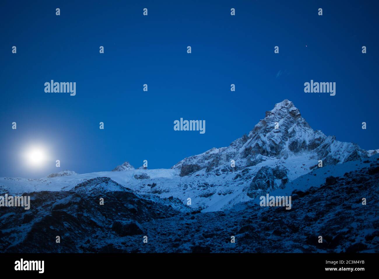 Breathtaking view of the snowy mountain summit on a blue sky background ...
