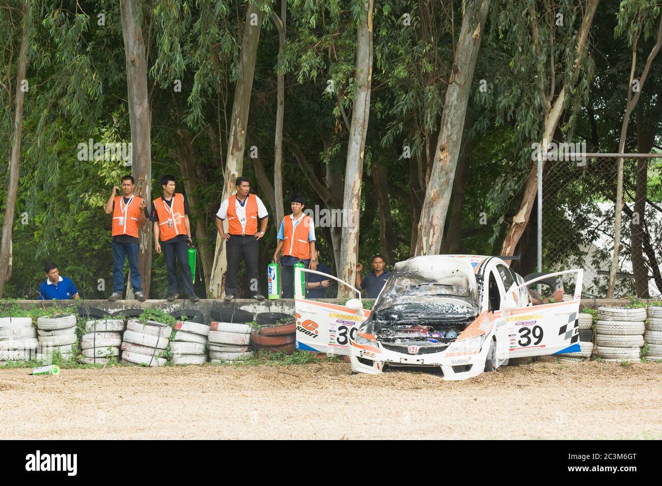 PATTAYA - JUNE 17: Rescue team and a burnt out in a Honda Civic with ...