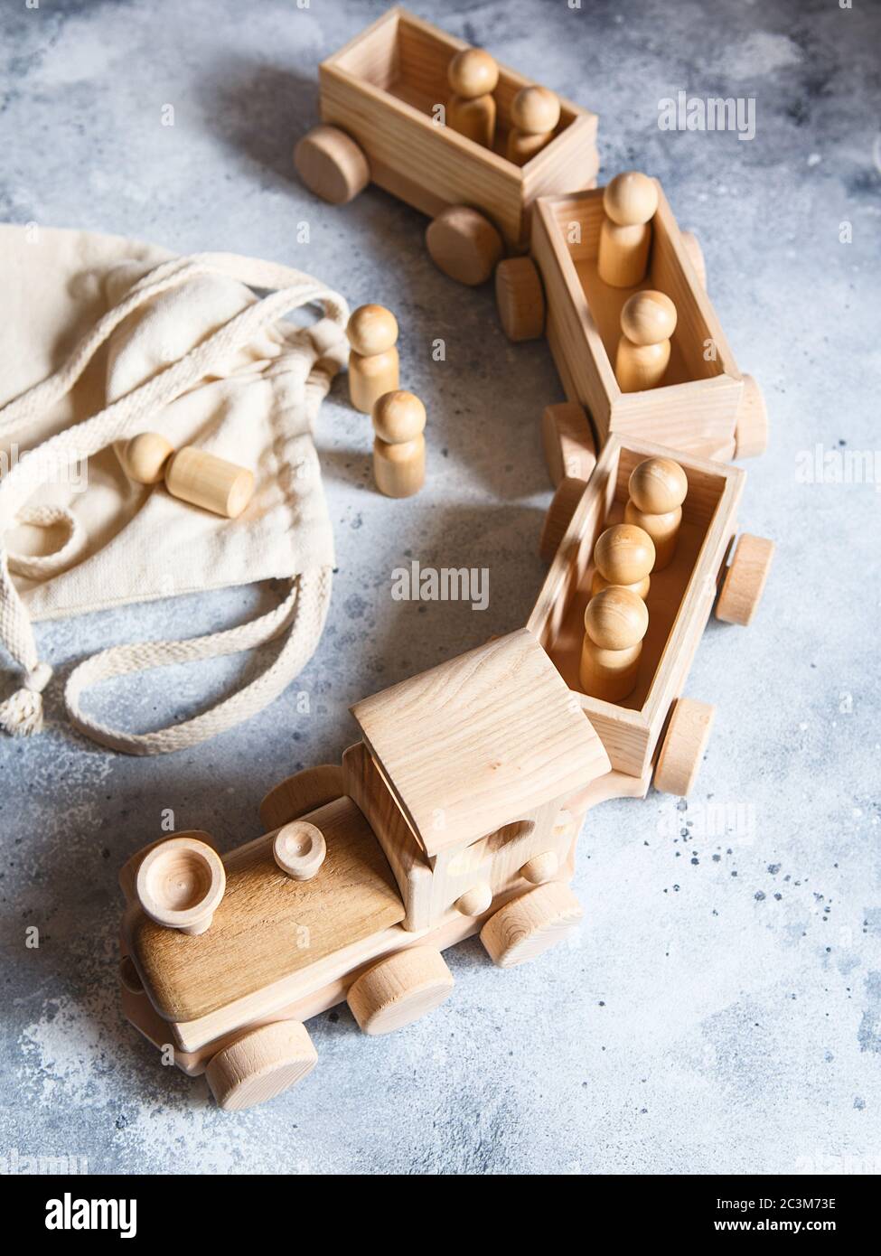 Children's wooden toys. Children wooden train with wagons. Natural wood ...