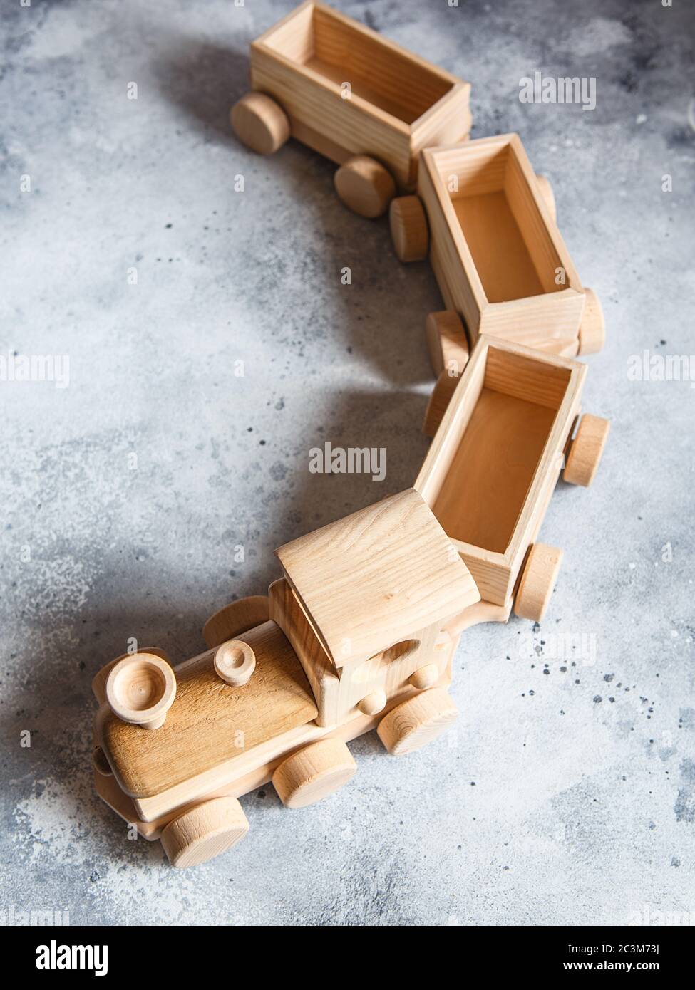 Children's wooden toys. Children wooden train with wagons. Natural wood ...