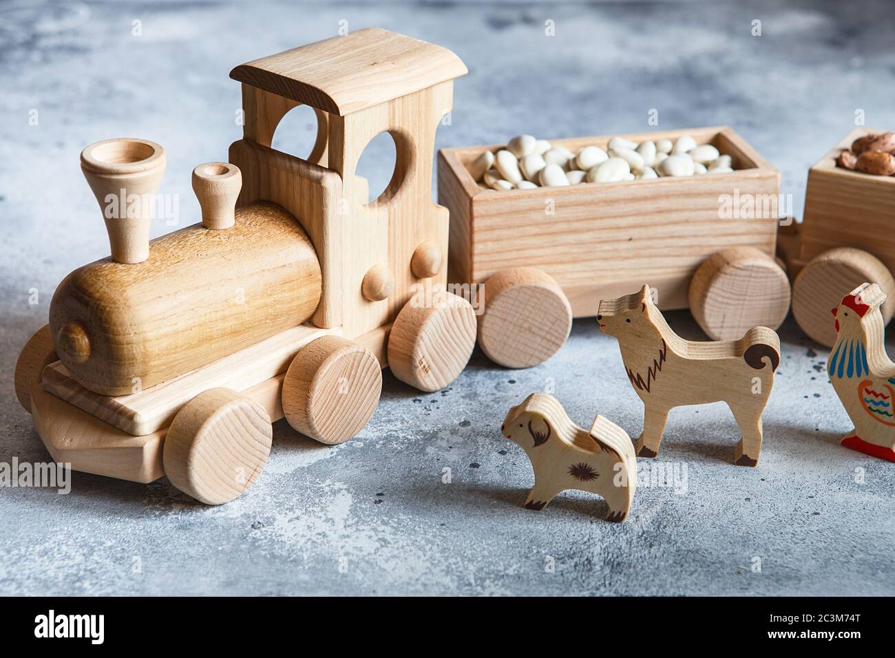 Children's wooden toys. Children wooden train with wagons. Natural wood ...