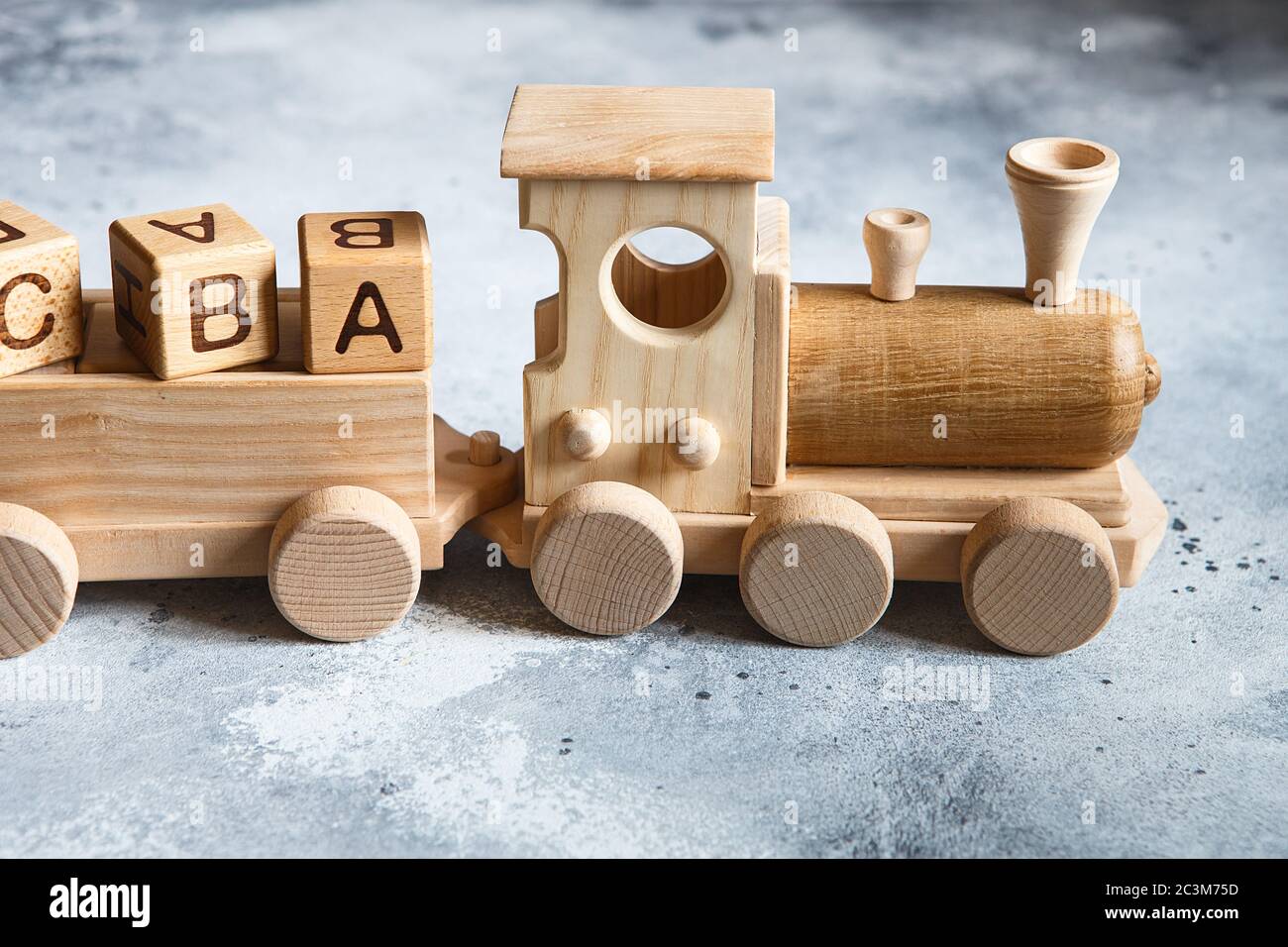 Children's wooden toys. Children wooden train with wagons. Natural wood ...