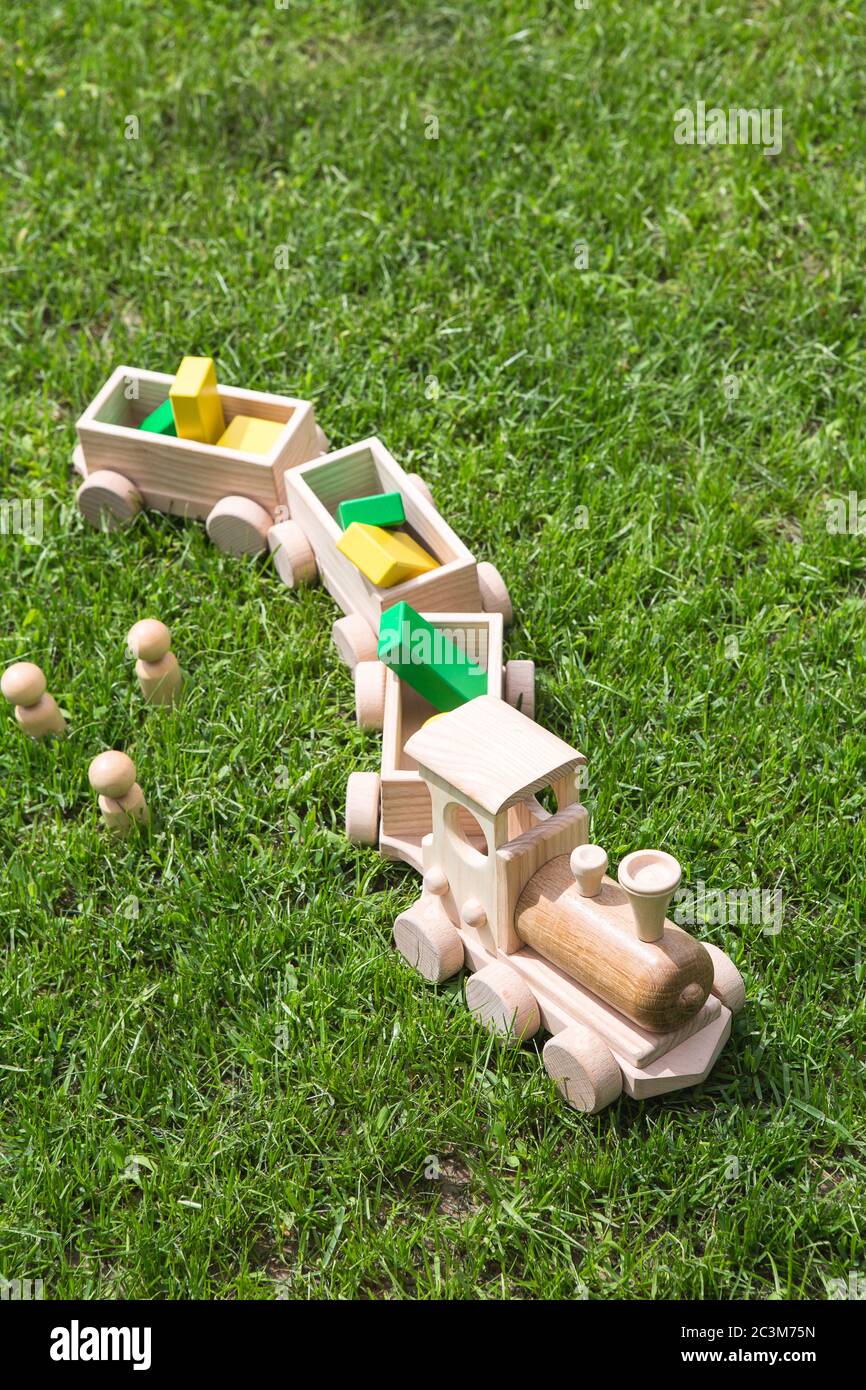 Children's wooden toys. Children wooden train with wagons. Natural wood ...