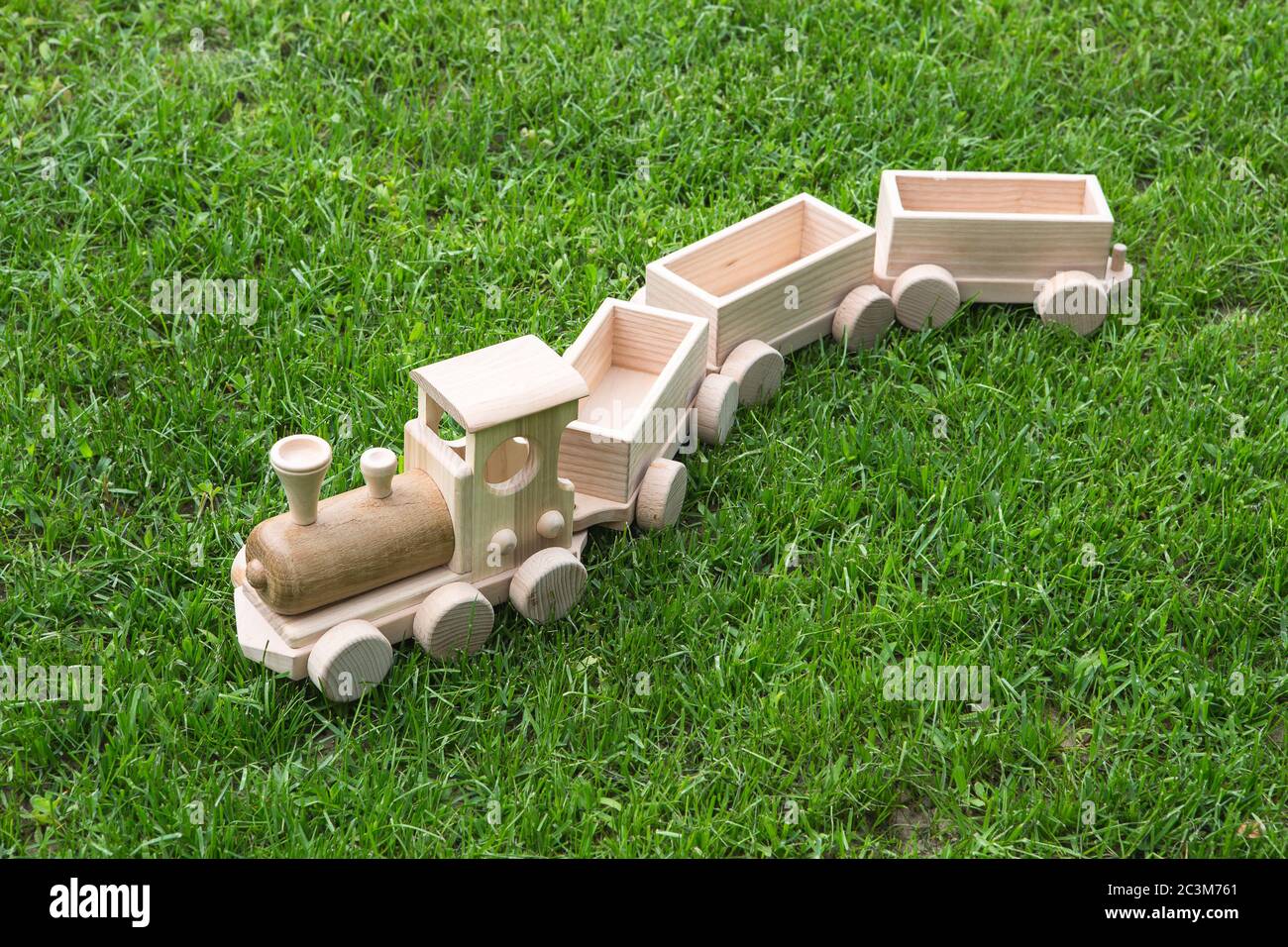 Children's wooden toys. Children wooden train with wagons. Natural wood ...