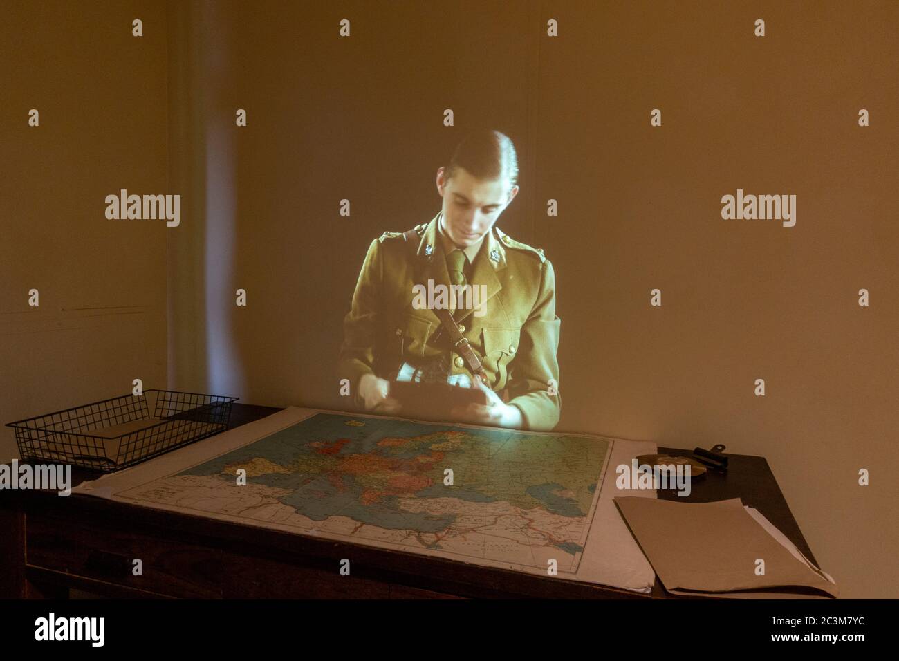 Diorama of WWII British officer looking down on a map on a desk in Hut ...