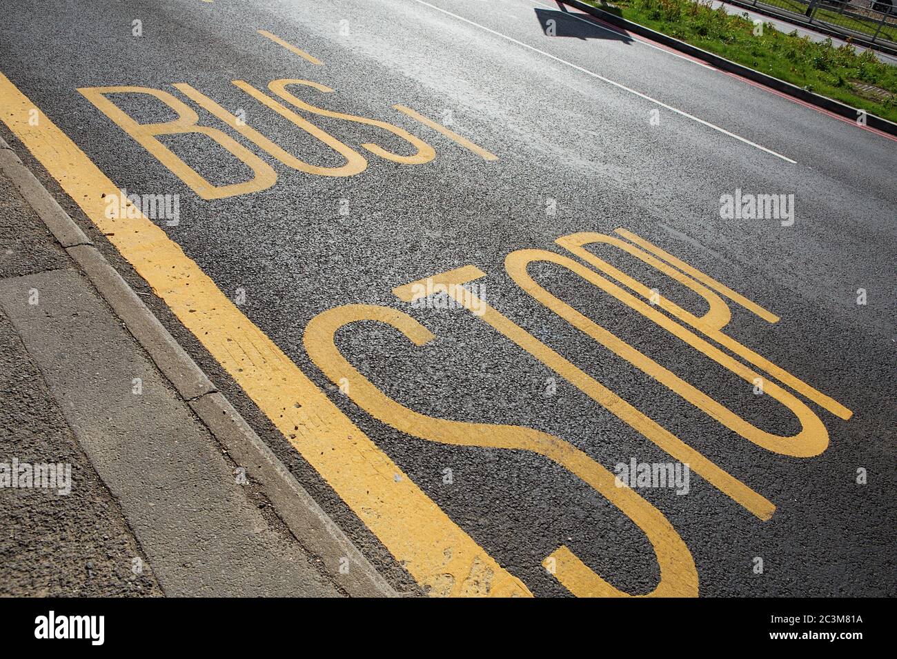 Bus stop sign with yellow paint on asphalt. Bus Stop Sign Painted on ...
