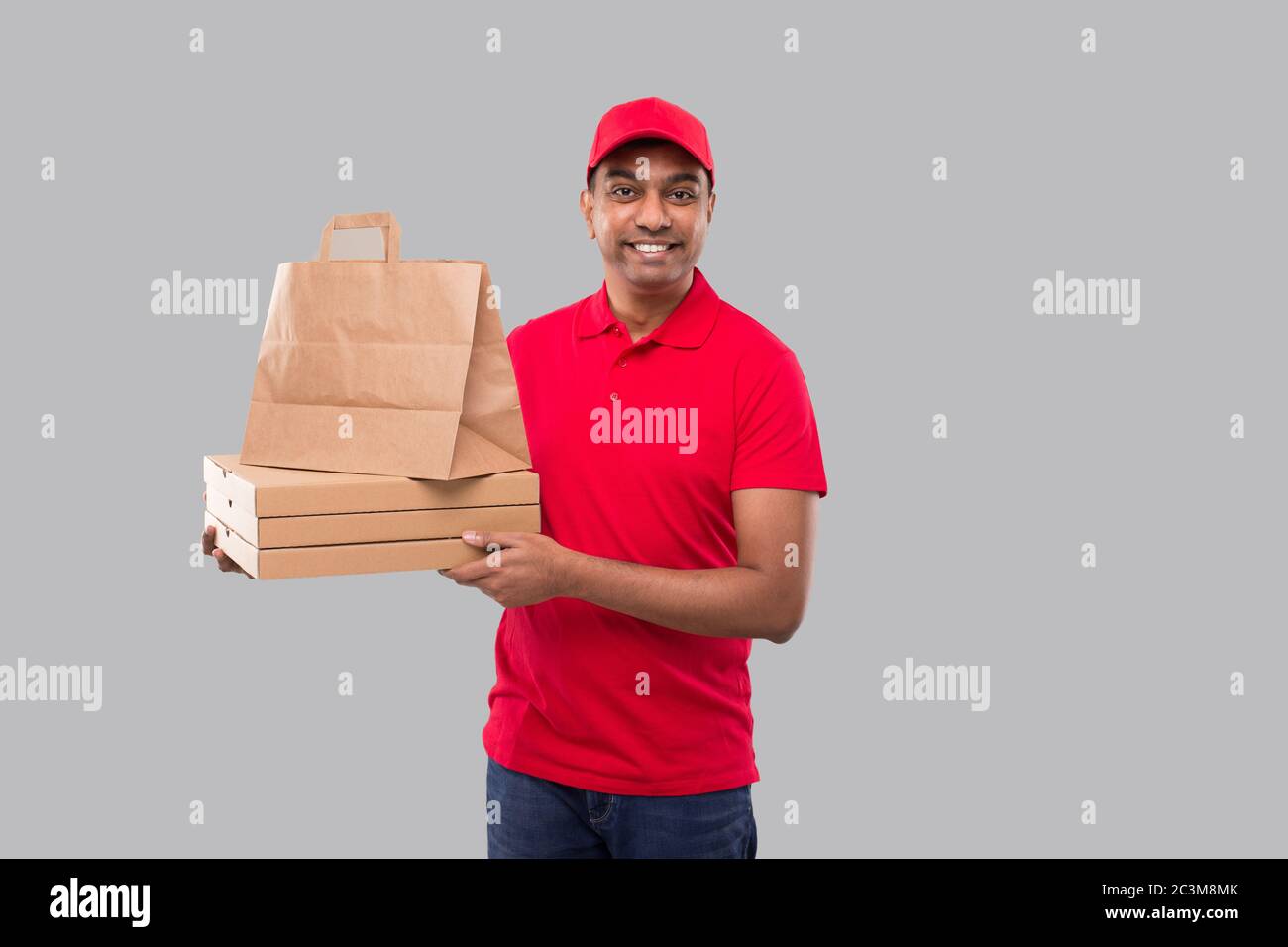 Delivery Man With Paper Bag and Three Pizza Box in Hands Isolated. Red ...