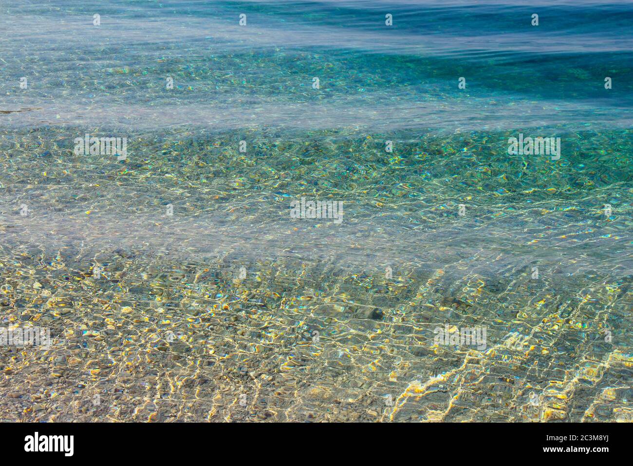 Beautiful background of crystal clear transparent sea water at sunny ...