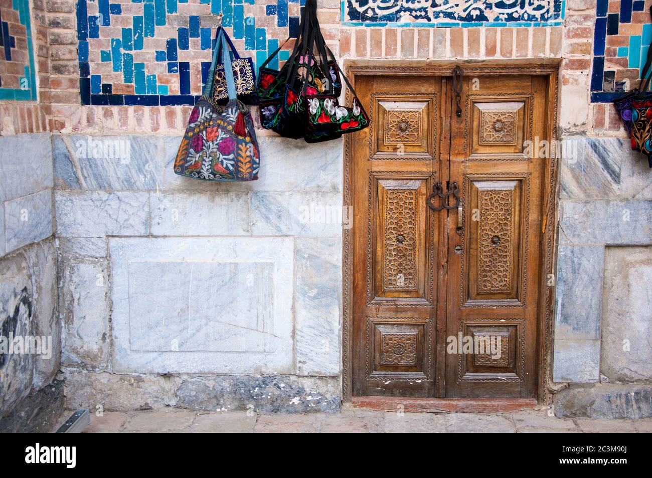 Old door with traditional decorative wooden carving at Registan Square ...