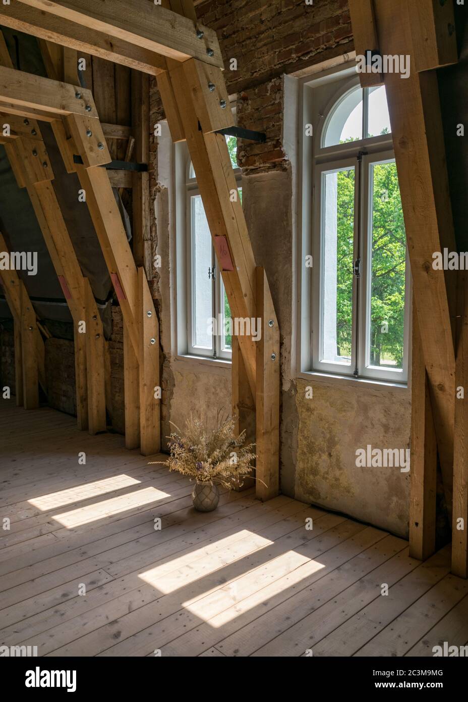 picture with wooden beams and windows in the roof attic, view out the ...