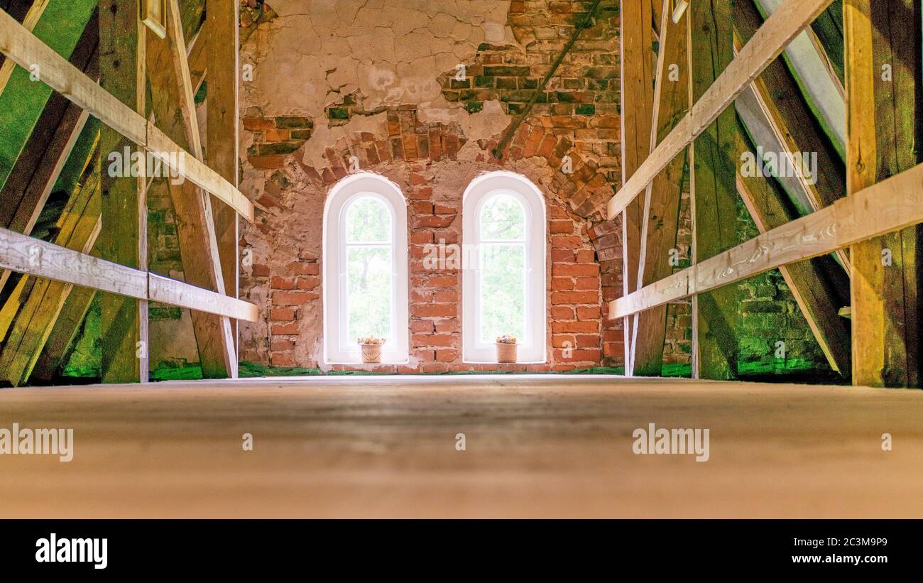 picture with wooden beams and windows in the roof attic, view out the ...